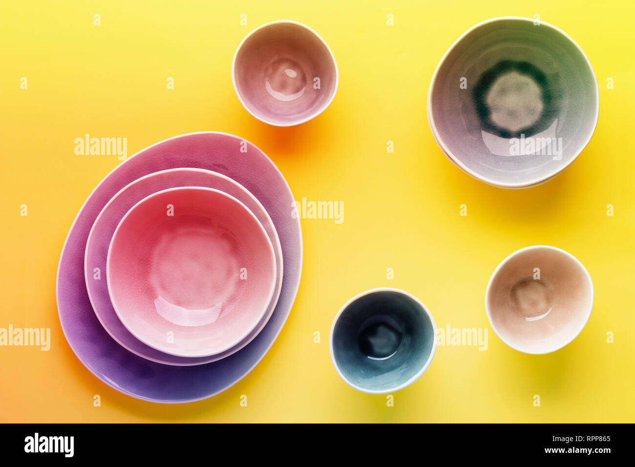 Beautiful blue, grey, beige dinnerware, plates bowls on yellow ...