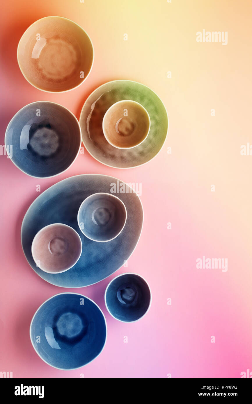 Beautiful blue, grey, beige dinnerware, plates bowls on pink background ...