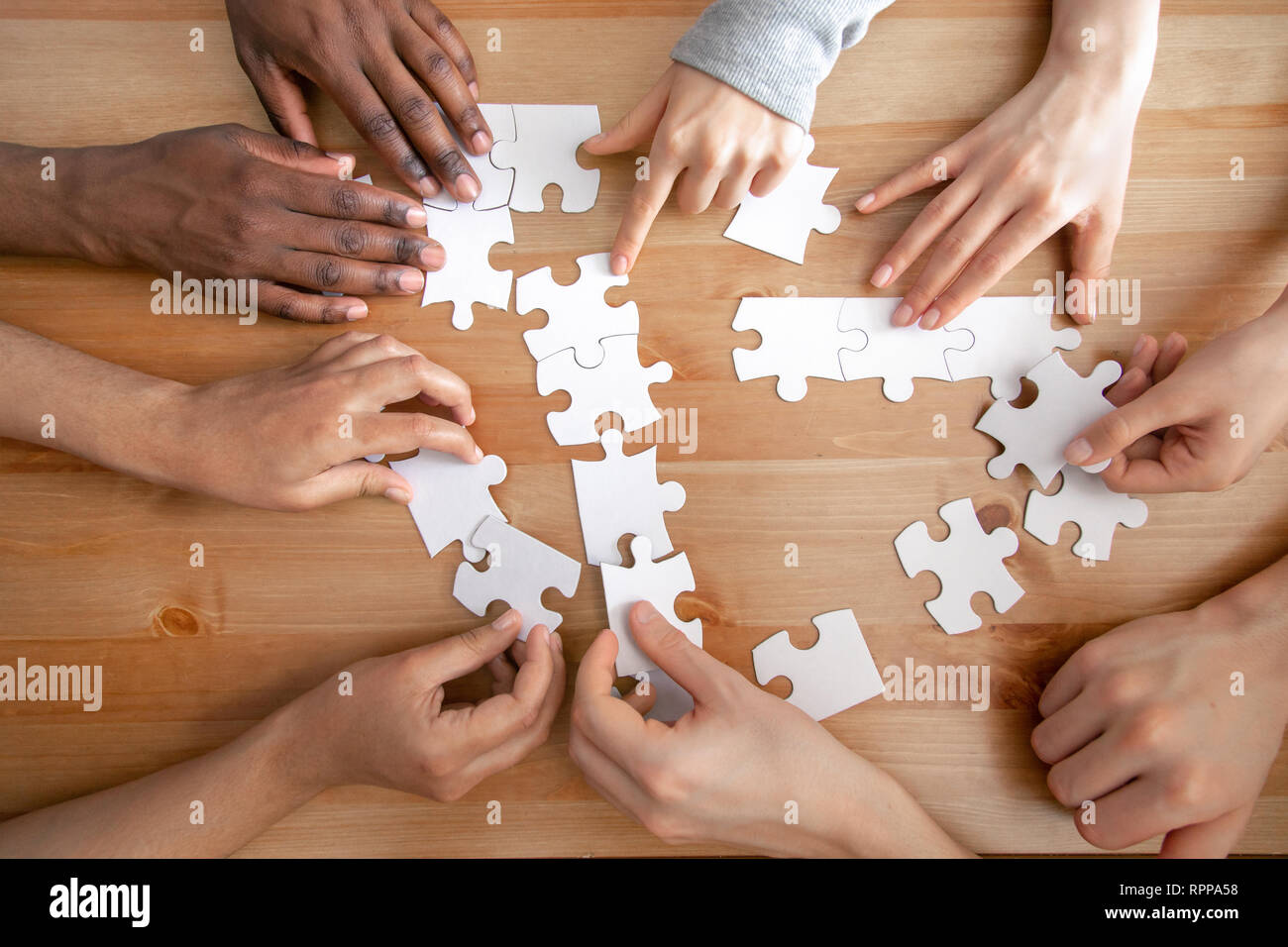 Assembling puzzle hi-res stock photography and images - Alamy