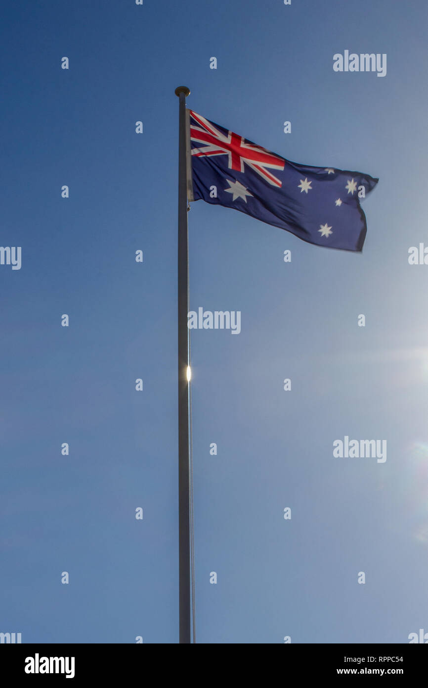 Australian flag slowly waving on the beautiful blue sky in Australia ...