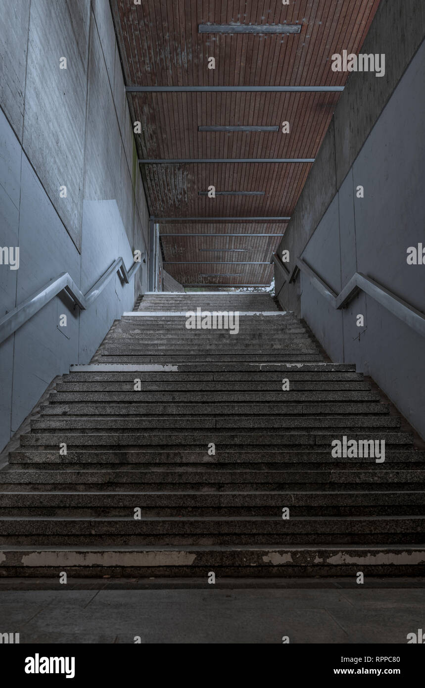 Underground passage stairways going up at a. Concrete walls and metal ...