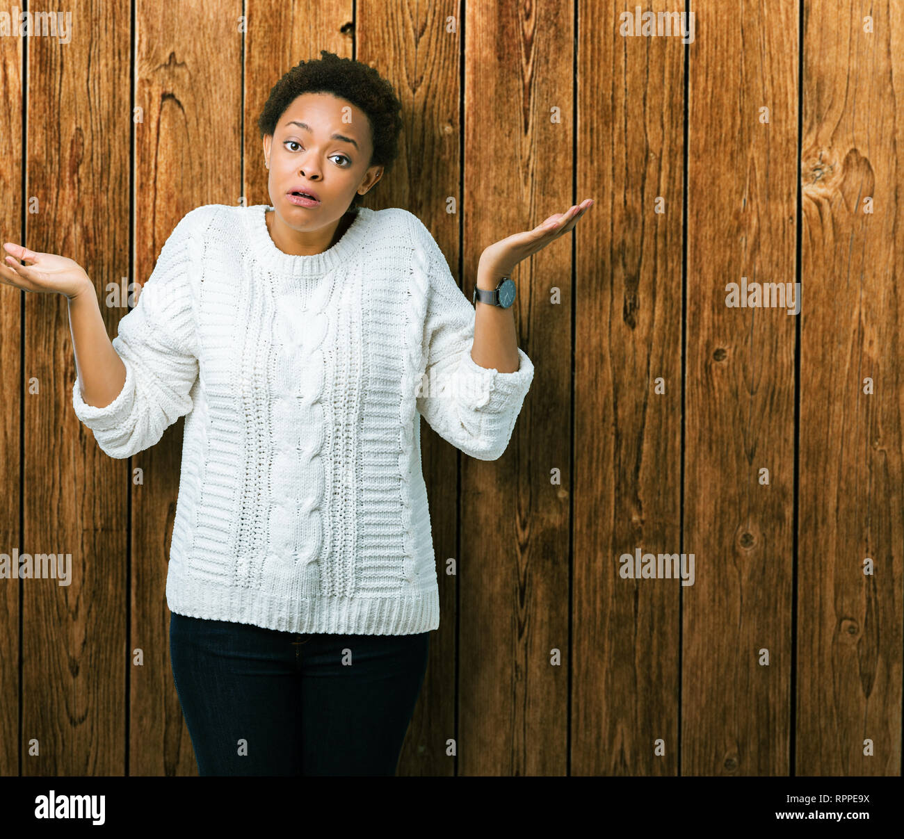 Beautiful young african american woman wearing sweater over isolated ...