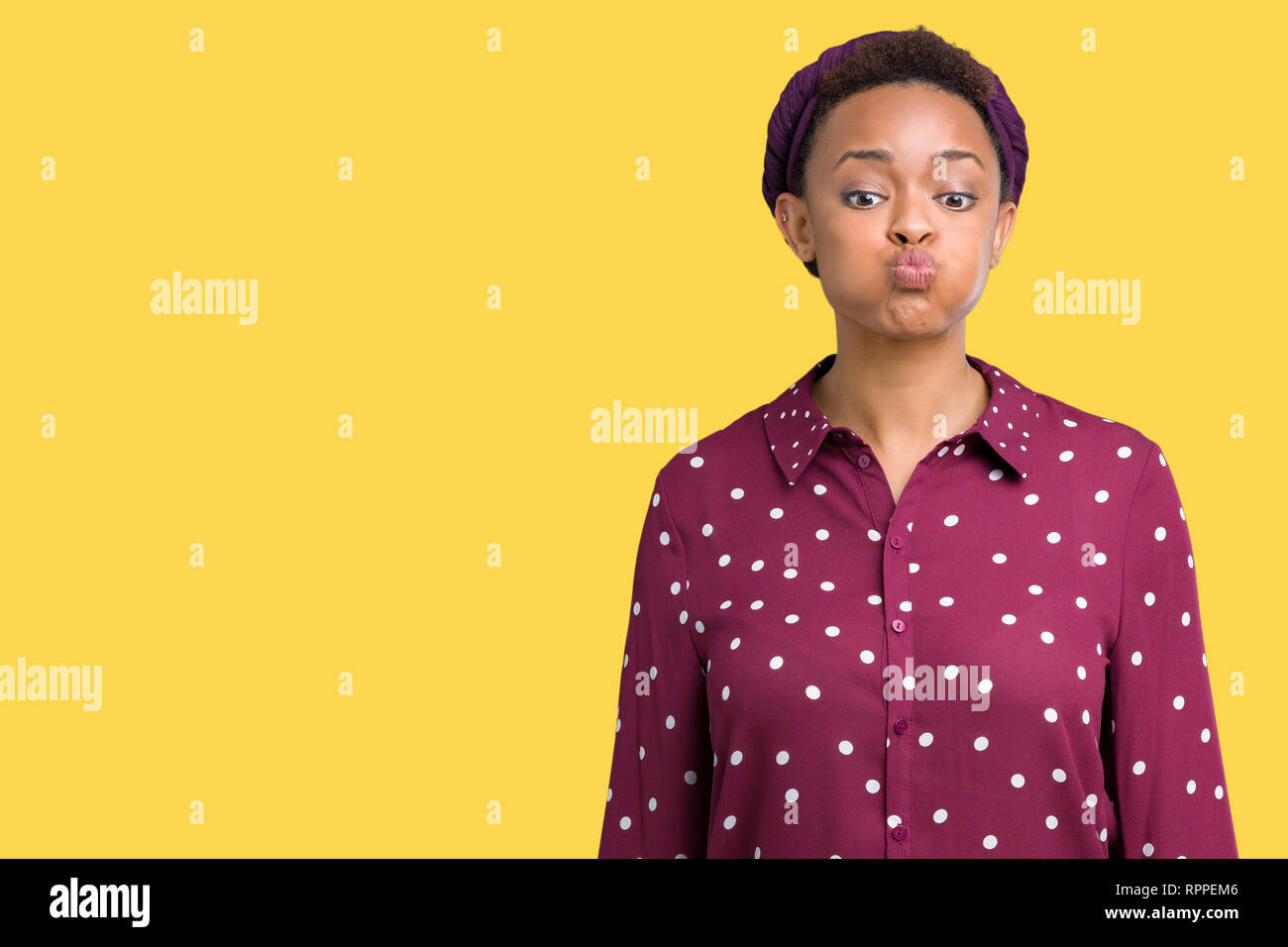 Beautiful young african american woman wearing head scarf over isolated ...