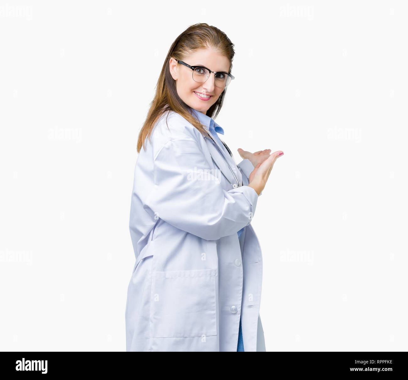Middle age mature doctor woman wearing medical coat over isolated ...