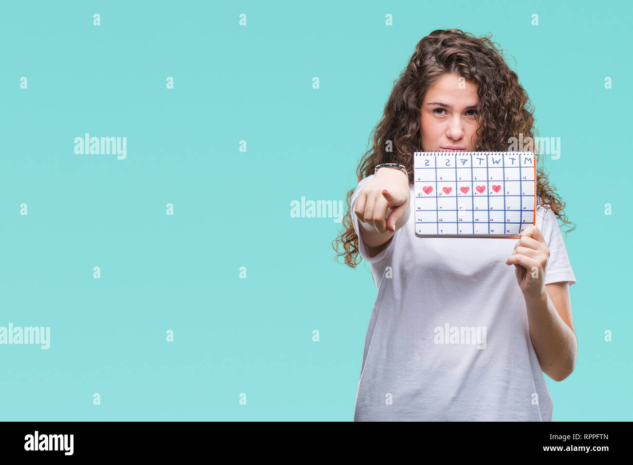 Young brunette girl holding menstruation calendar over isolated ...