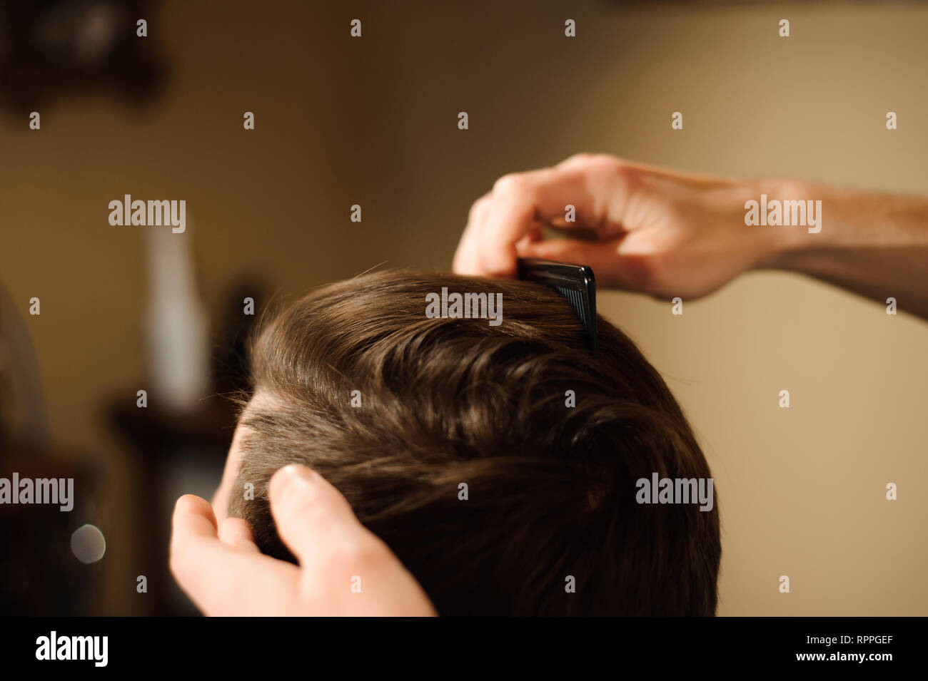 Master cuts hair and beard of men in the barbershop Stock Photo - Alamy