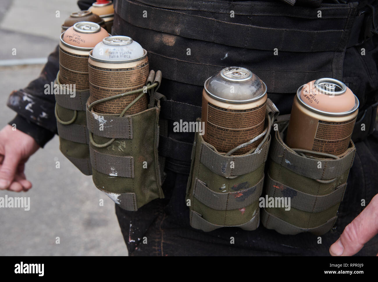 Berlin, Germany. 21st Feb, 2019. A sprayer wears a belt full of spray ...