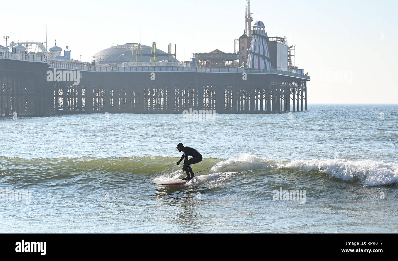 Brighton, East Sussex, UK. 23rd Feb 2019. A surfer by Brighton Palace ...