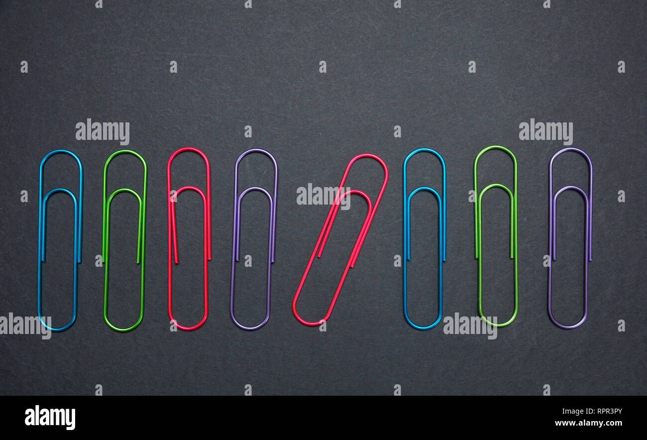 Business, school supplies. Colorful big paper clips on black color ...