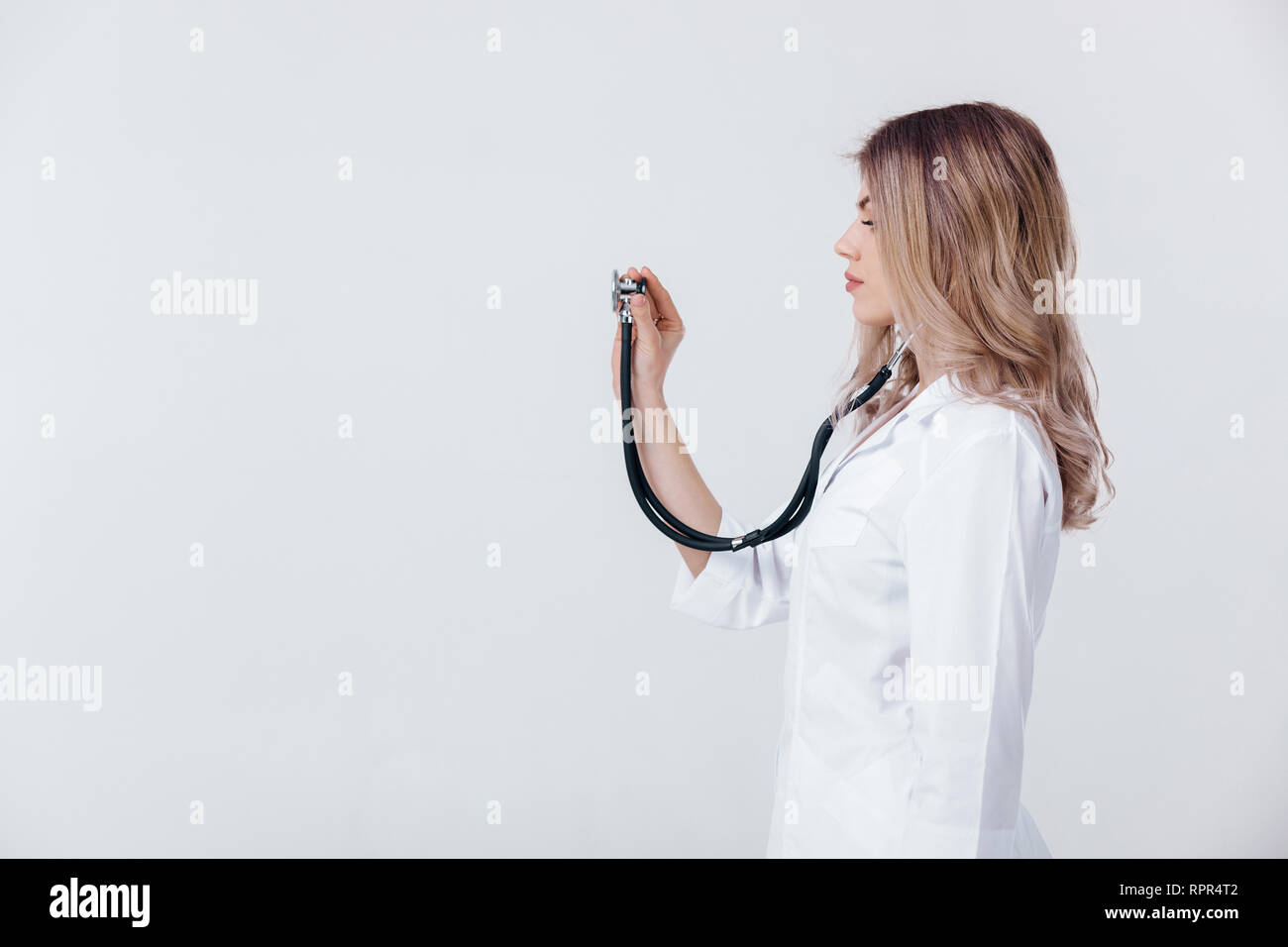 Medical physician doctor woman in white coat examining with stethoscope ...