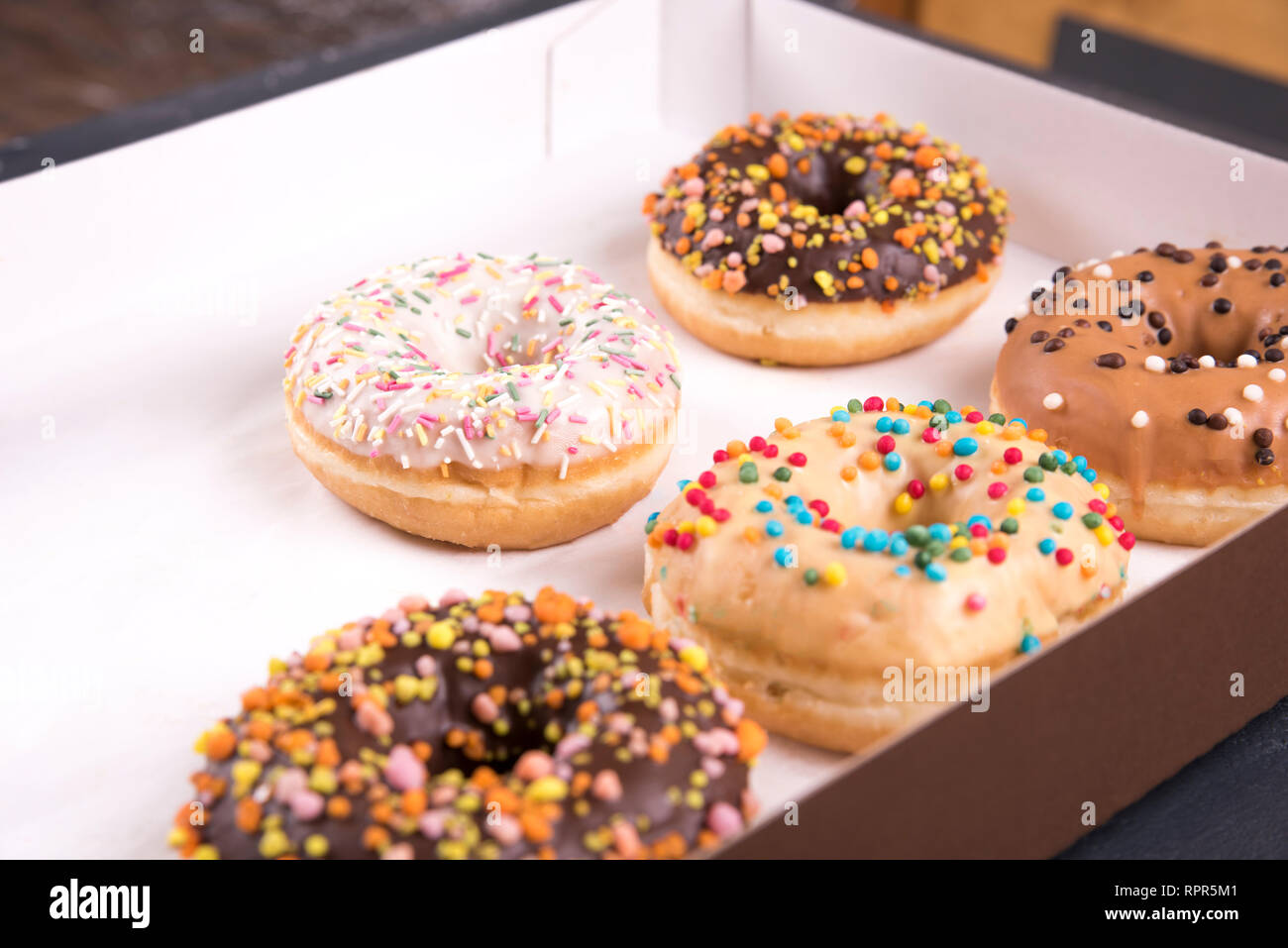 box of sweet fresh donuts with filling Stock Photo - Alamy