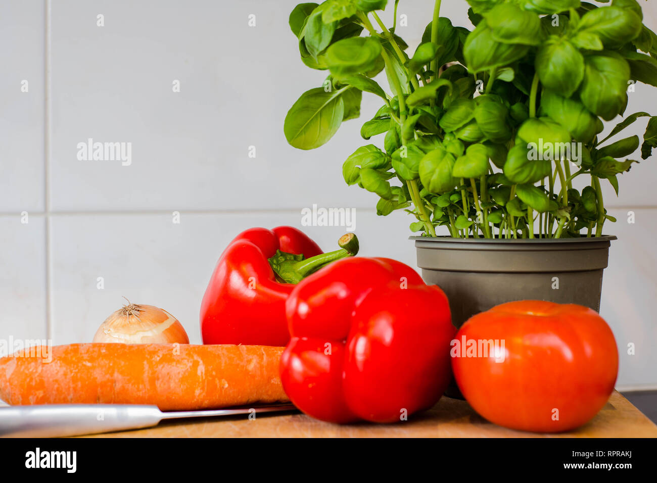 Vegetables Fresh coriander,carrot, paprika on the kitchen counter Stock ...