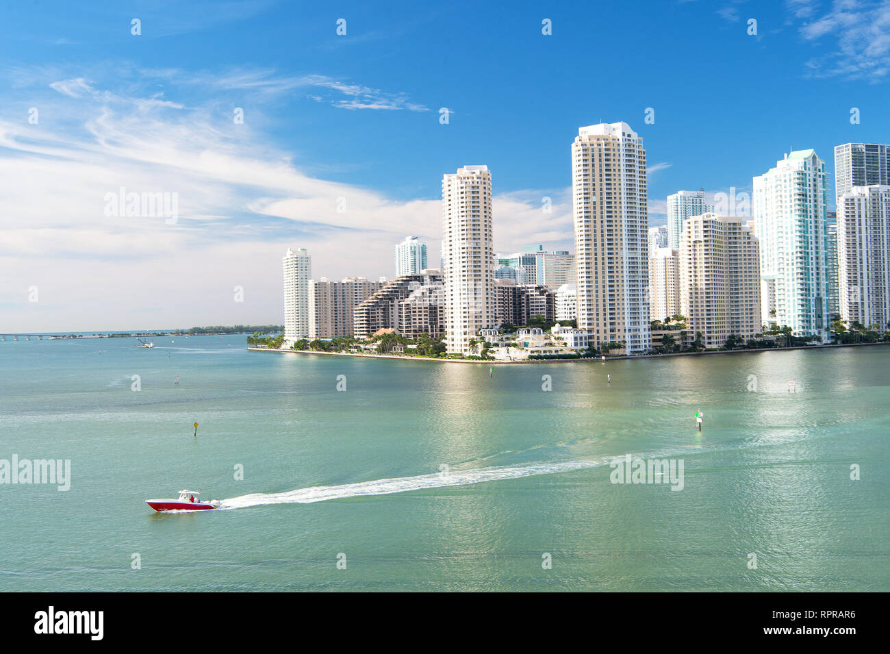 Aerial view of Miami skyscrapers with blue cloudy sky,white boat ...
