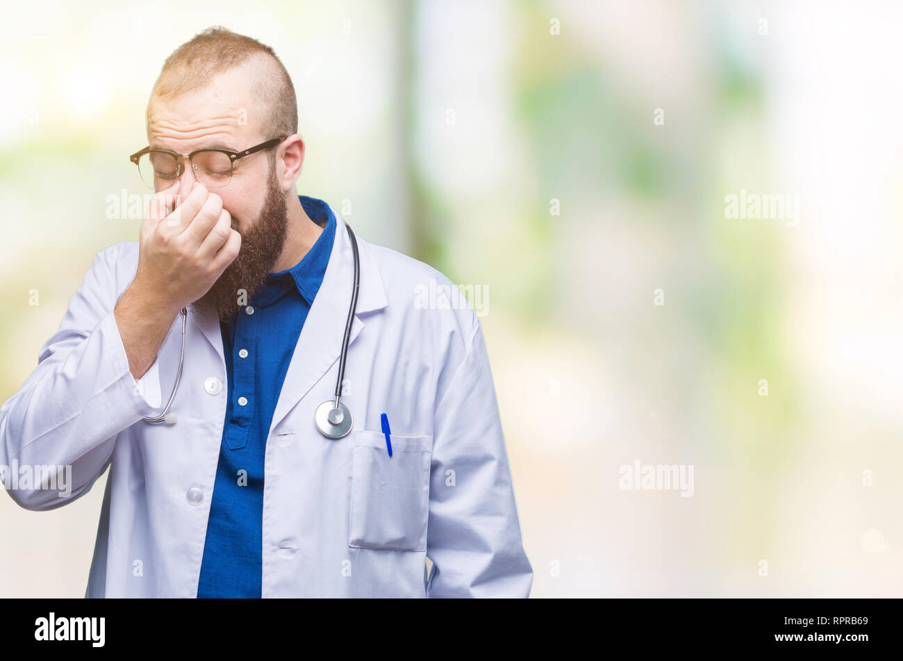 Young caucasian doctor man wearing medical white coat over isolated ...