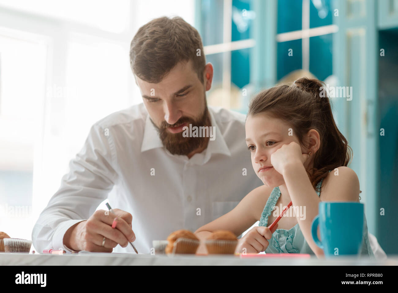 Dad and daughter doing homework Stock Photo - Alamy