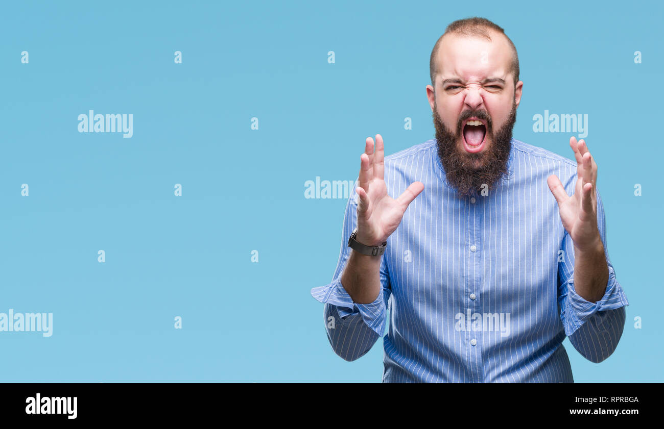 Young caucasian hipster man over isolated background crazy and mad ...