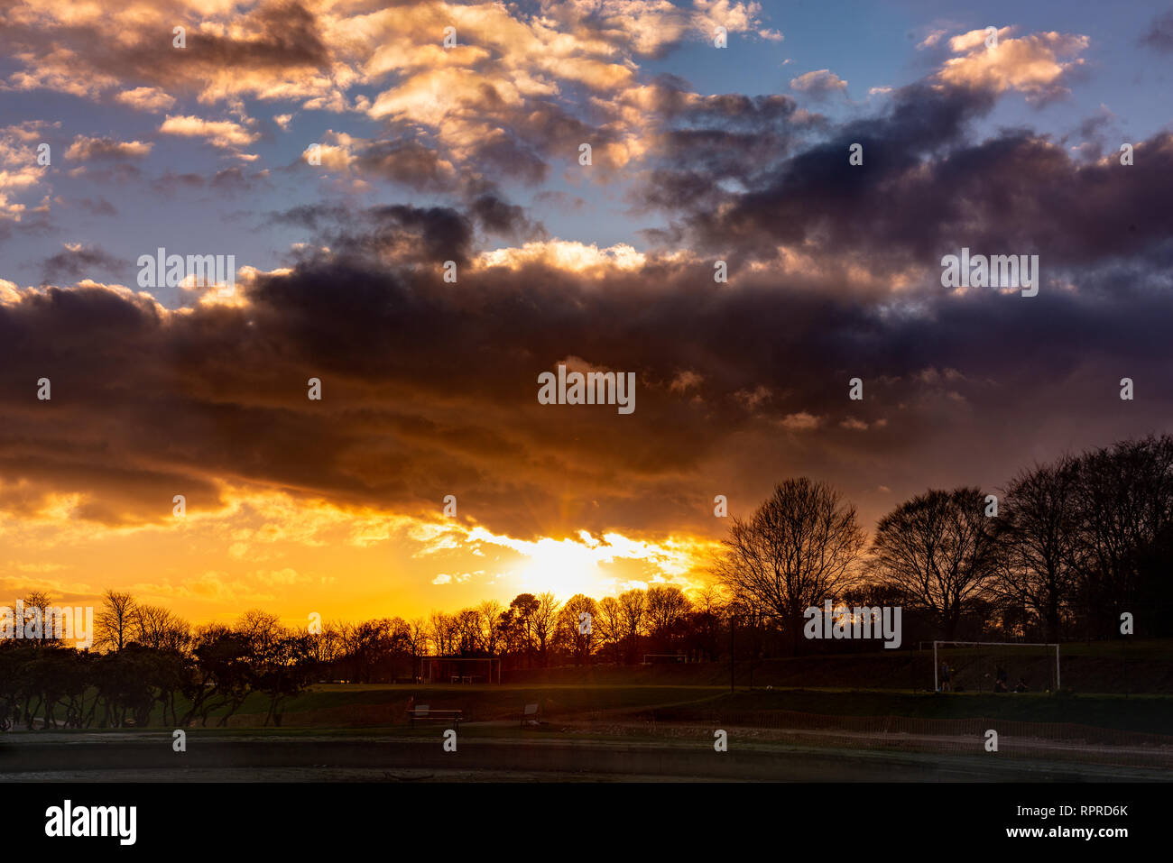 Fiery orange dramatic sunset over soccer field Stock Photo - Alamy