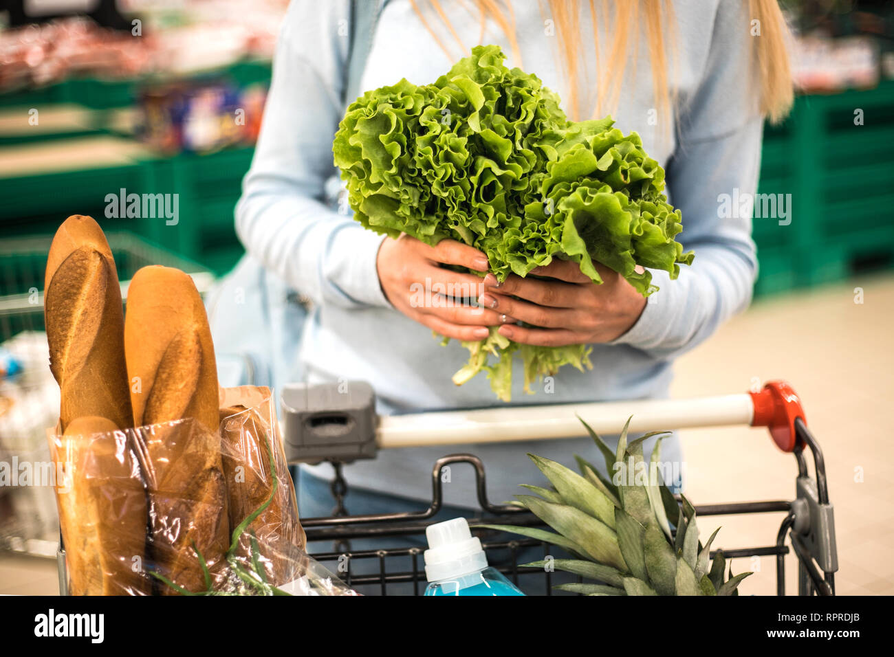Woman choosing green leafy vegetables in grocery Stock Photo - Alamy