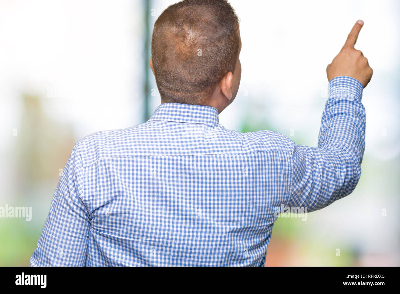 Middle age arab business man over isolated background Posing backwards ...