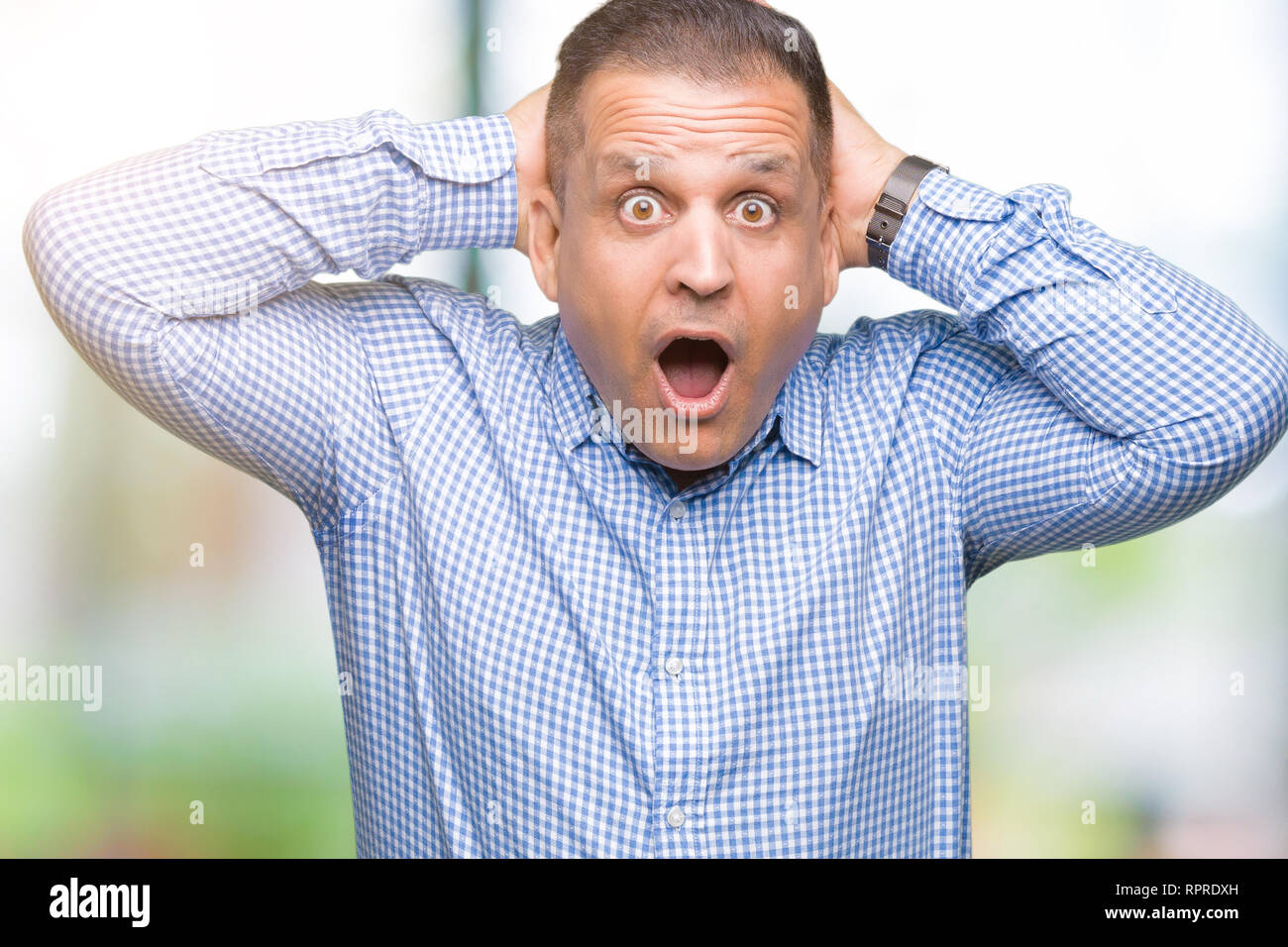 Middle age arab business man over isolated background Crazy and scared ...