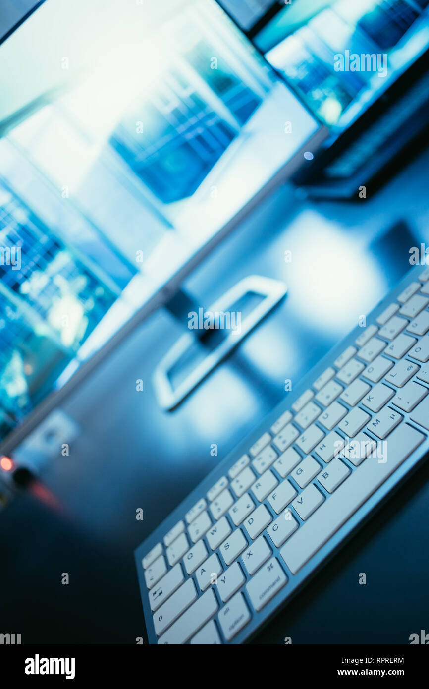Freelancer’s workplace: Keyboard in the foreground, blurry screen in ...