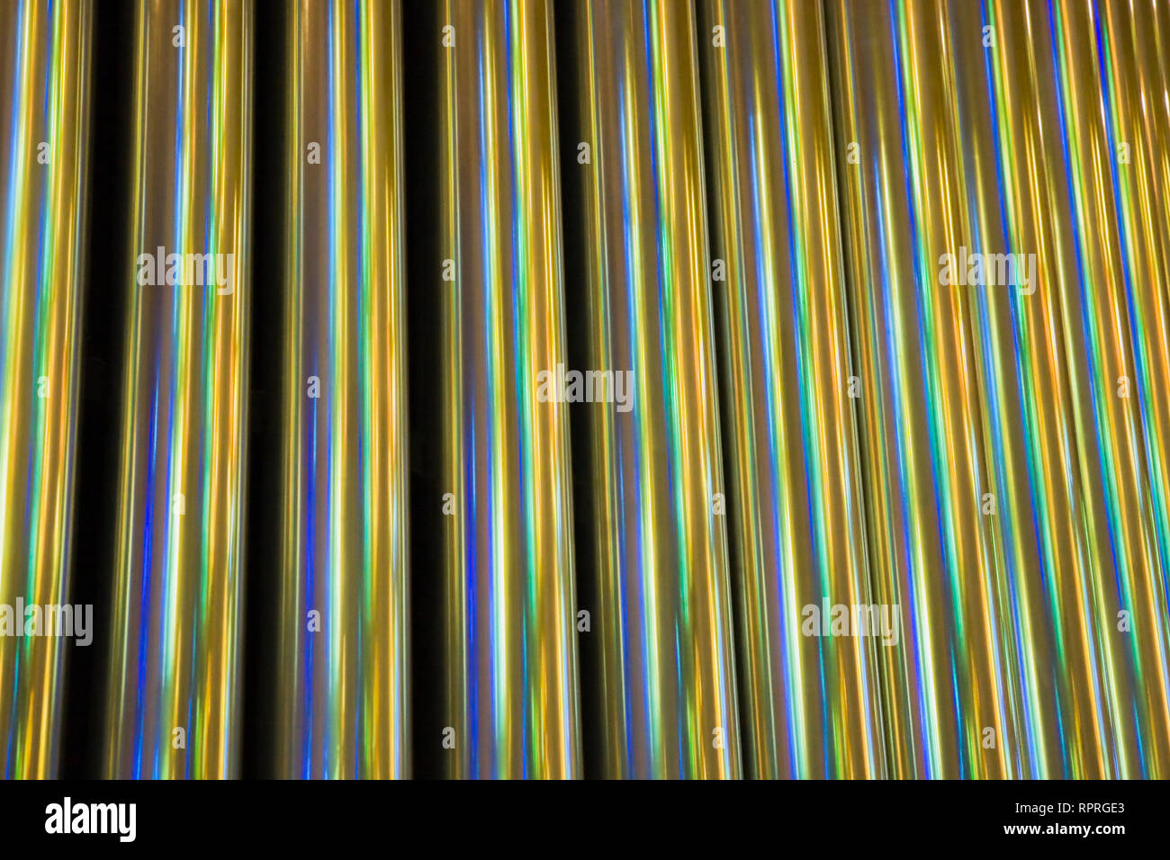 Close-up of light reflections on brass metal pipes Stock Photo - Alamy