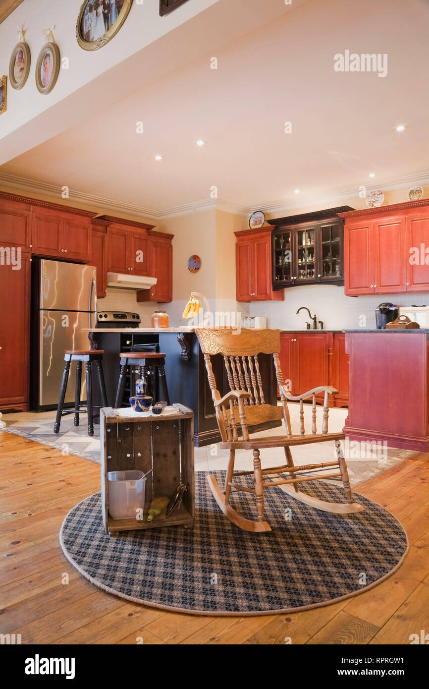 Antique rocking chair and modern furnishings in the kitchen of an old ...
