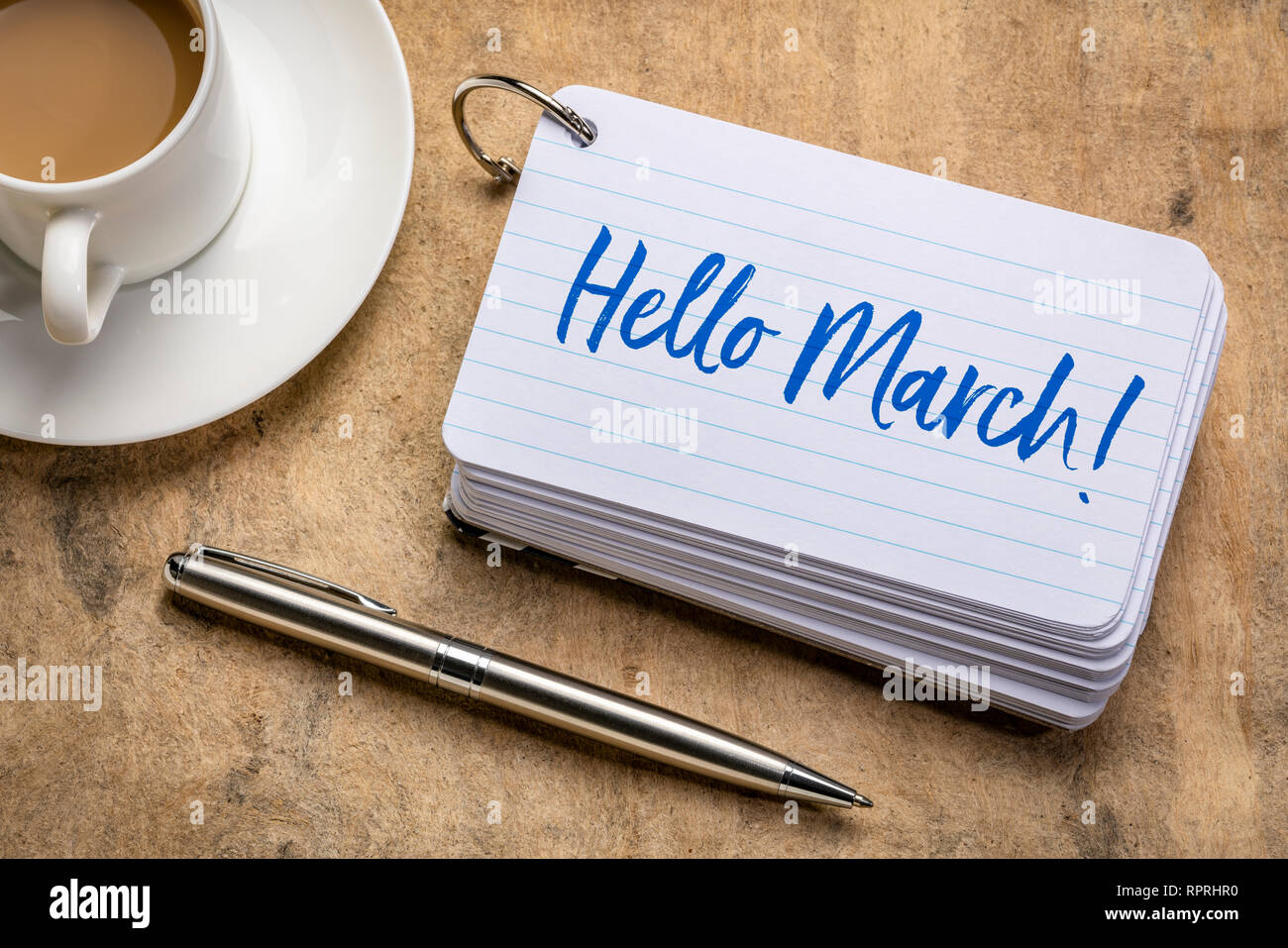 Hello March! Handwriting on a stack of index cards with a cup of coffee ...
