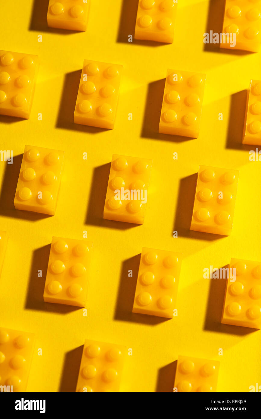 Yellow unicolour plastic geometric cubes. Construction toys on ...