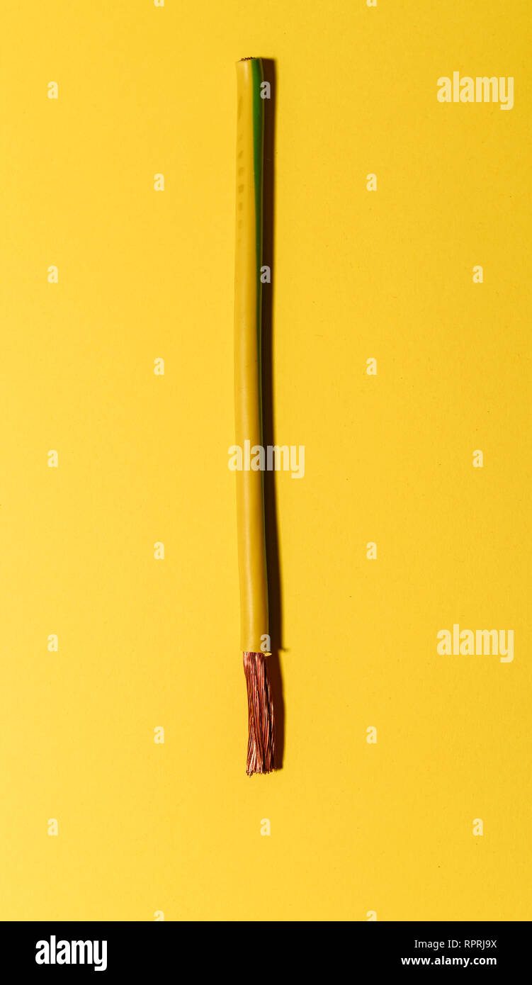 Electrical cable on yellow background. Spread out copper wires ...