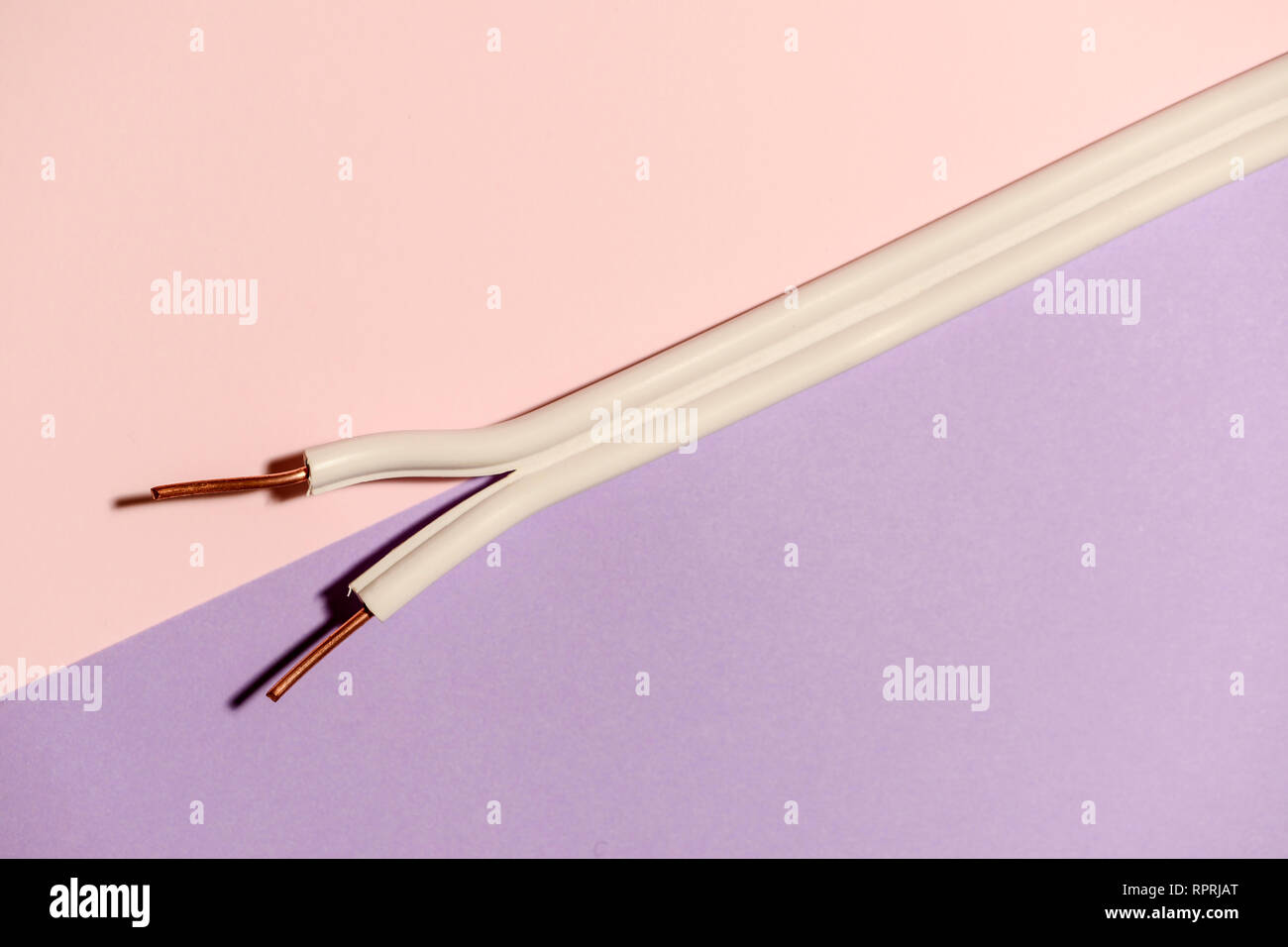 Electrical cable on pink pastel background. Spread out copper wires ...