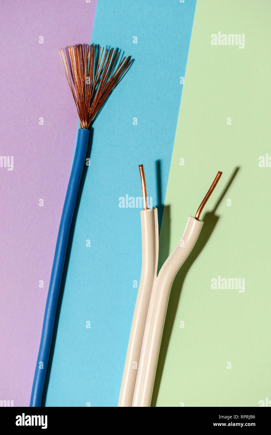 Electrical cable on pink and blue background. Spread out copper wires ...