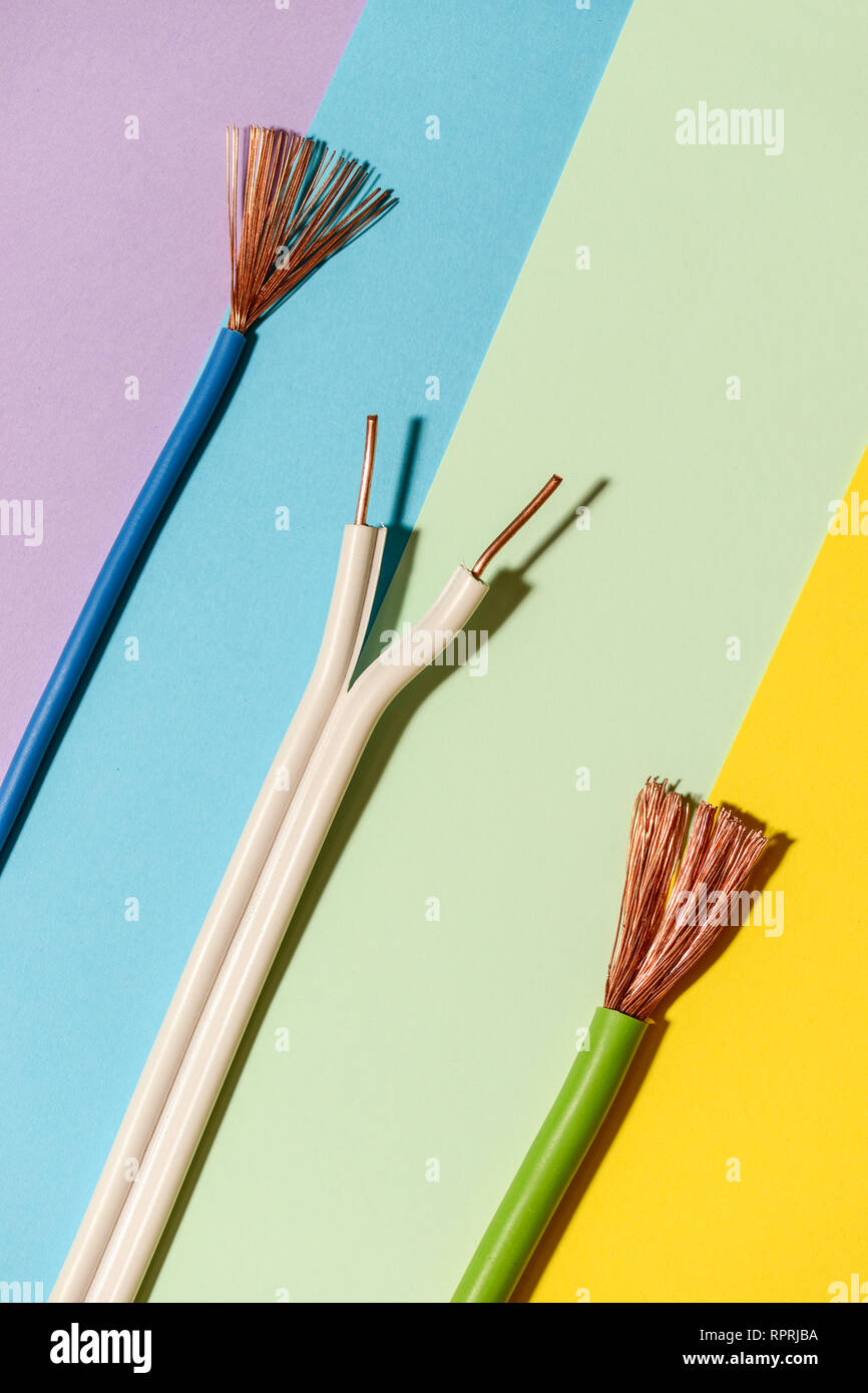 Electrical cable on pink and blue background. Spread out copper wires ...