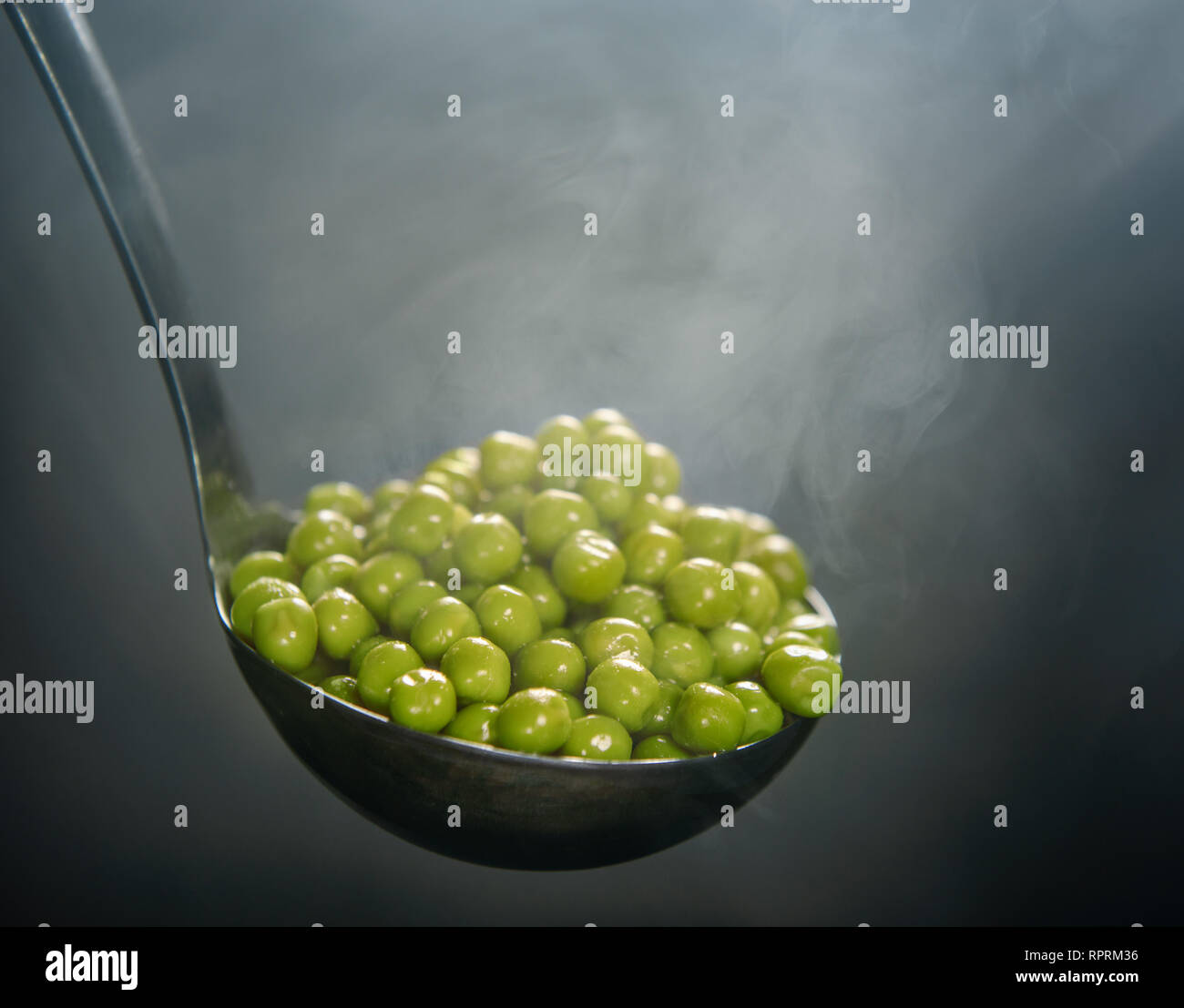 Boiled peas in a scoop on a dark background with smoke Stock Photo - Alamy