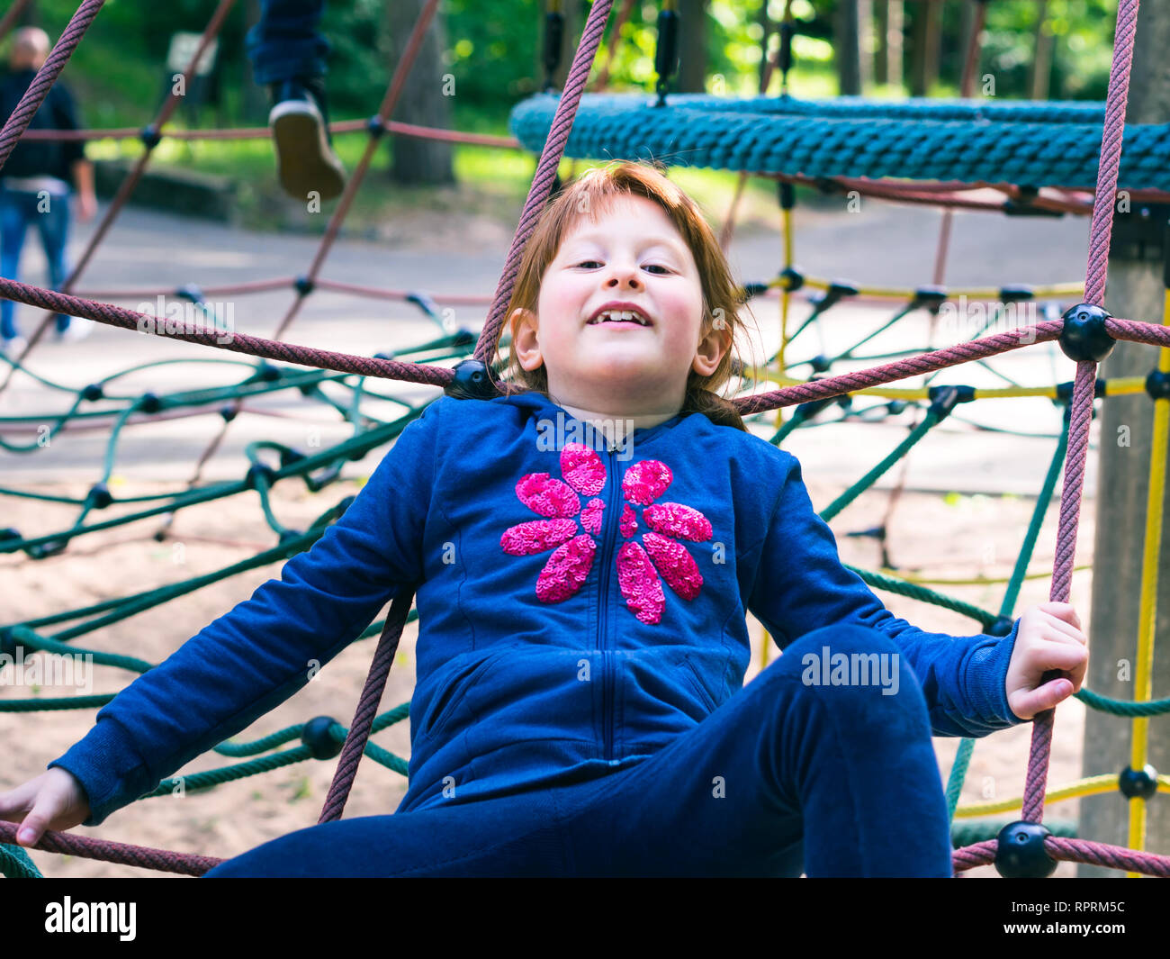 Little 9-year old redhead girl playing on playground Stock Photo - Alamy