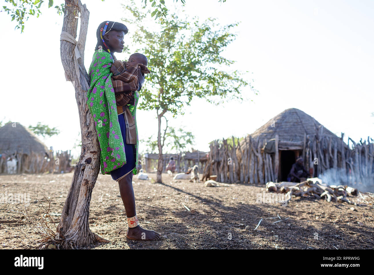 Zemba woman with child in the morning in a village near Epupa Falls ...