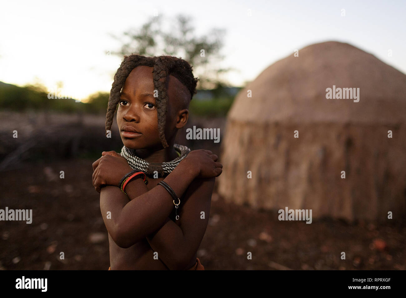 Himba girl with two braids and jewellery, portrait, Himba hut, Himba ...