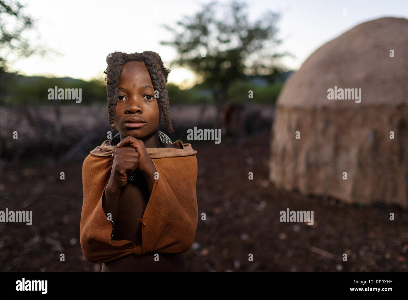 Himba girl with two braids and jewellery, portrait, Himba hut, Himba ...