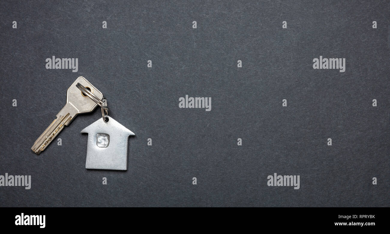 Real estate, home concept, House key on black color background, copy ...