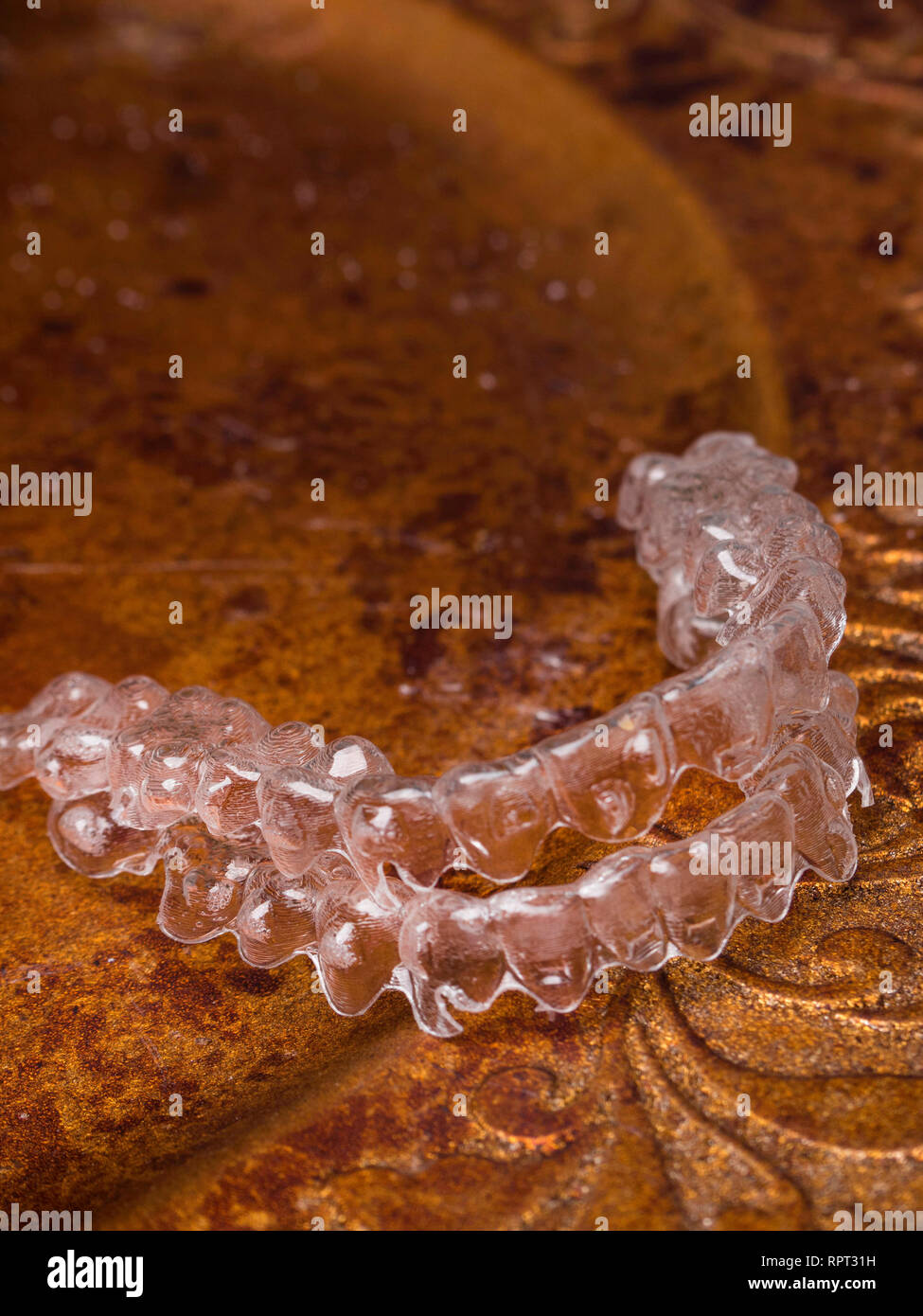 teeth aligners. Invisible brackets on gold plate Shine smile concept ...