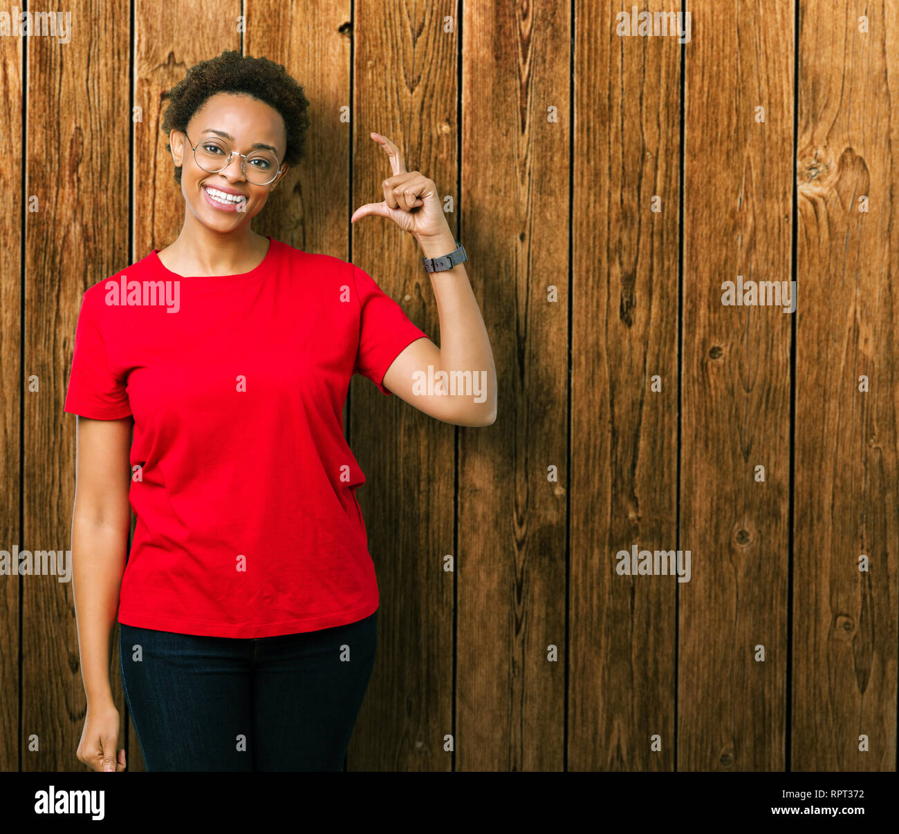 Beautiful young african american woman wearing glasses over isolated ...