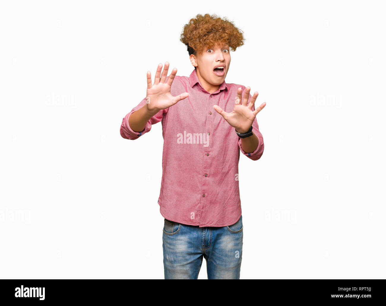 Young handsome business man with afro hair afraid and terrified with ...