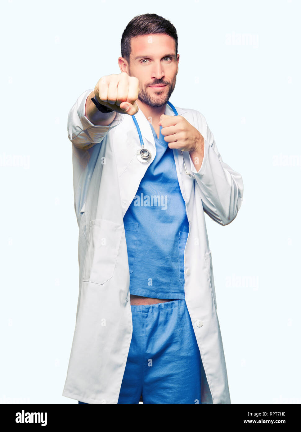 Handsome doctor man wearing medical uniform over isolated background ...