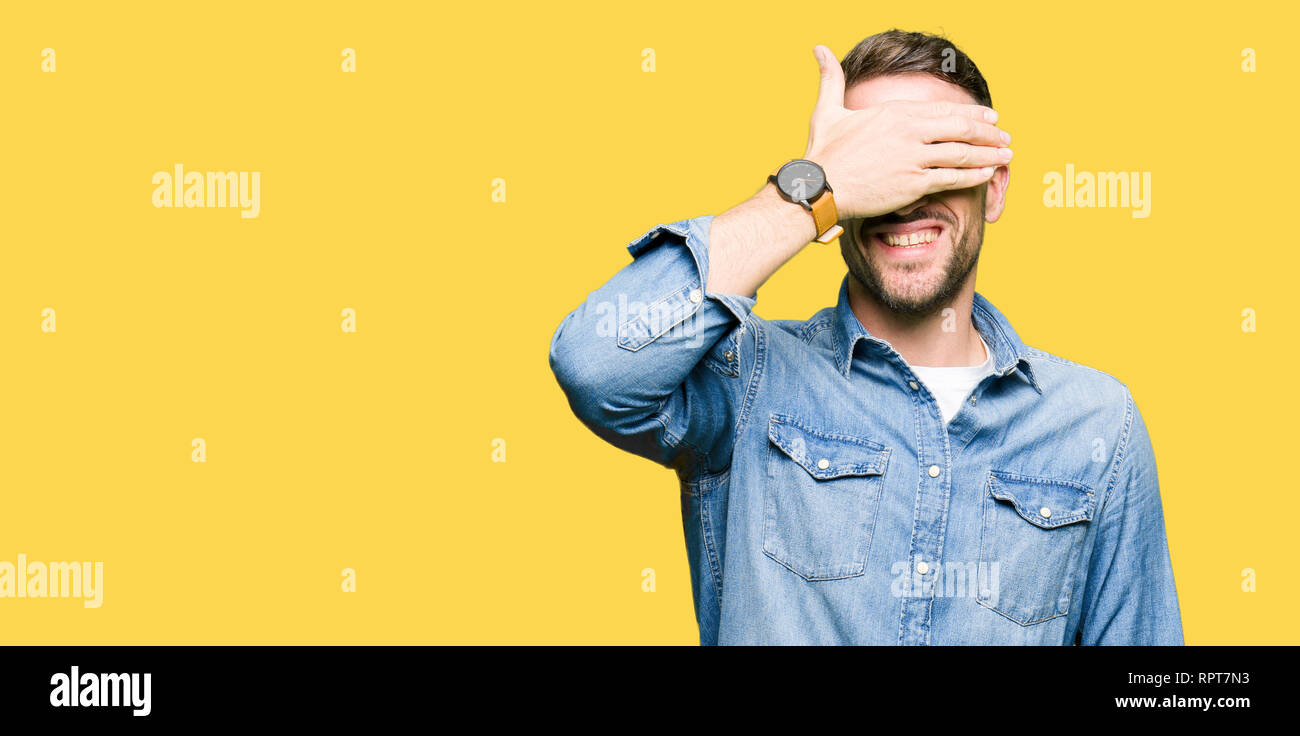 Handsome man wearing glasses smiling and laughing with hand on face ...