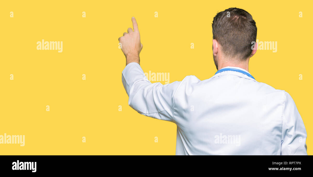 Handsome doctor man wearing medical uniform over isolated background ...