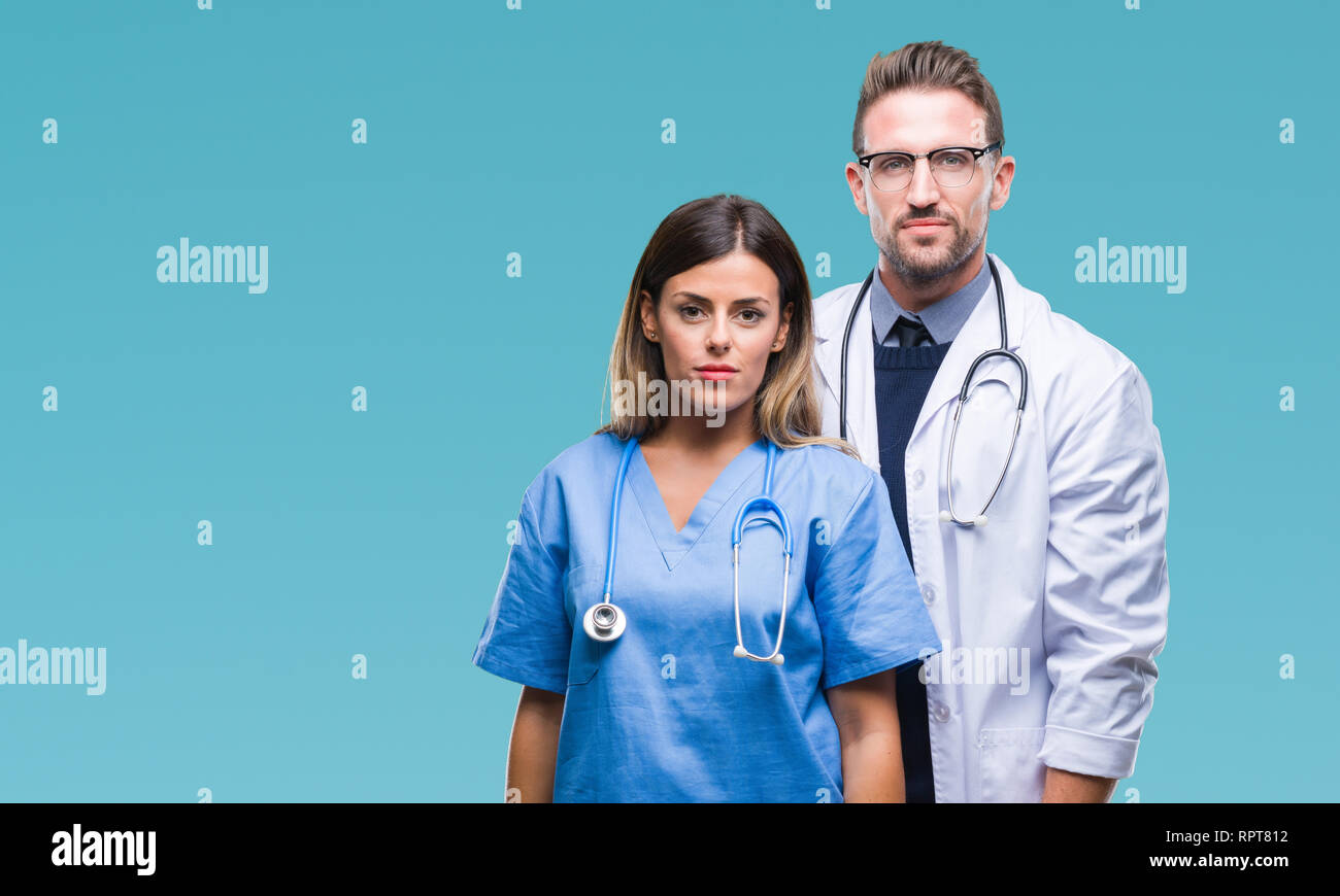 Young couple of doctor and surgeon over isolated background with ...