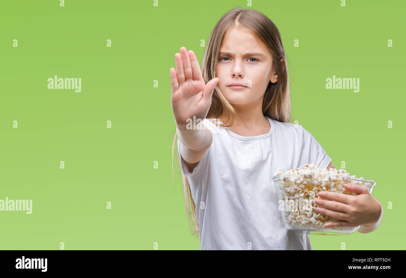 Young beautiful girl eating popcorn snack isolated background with open ...