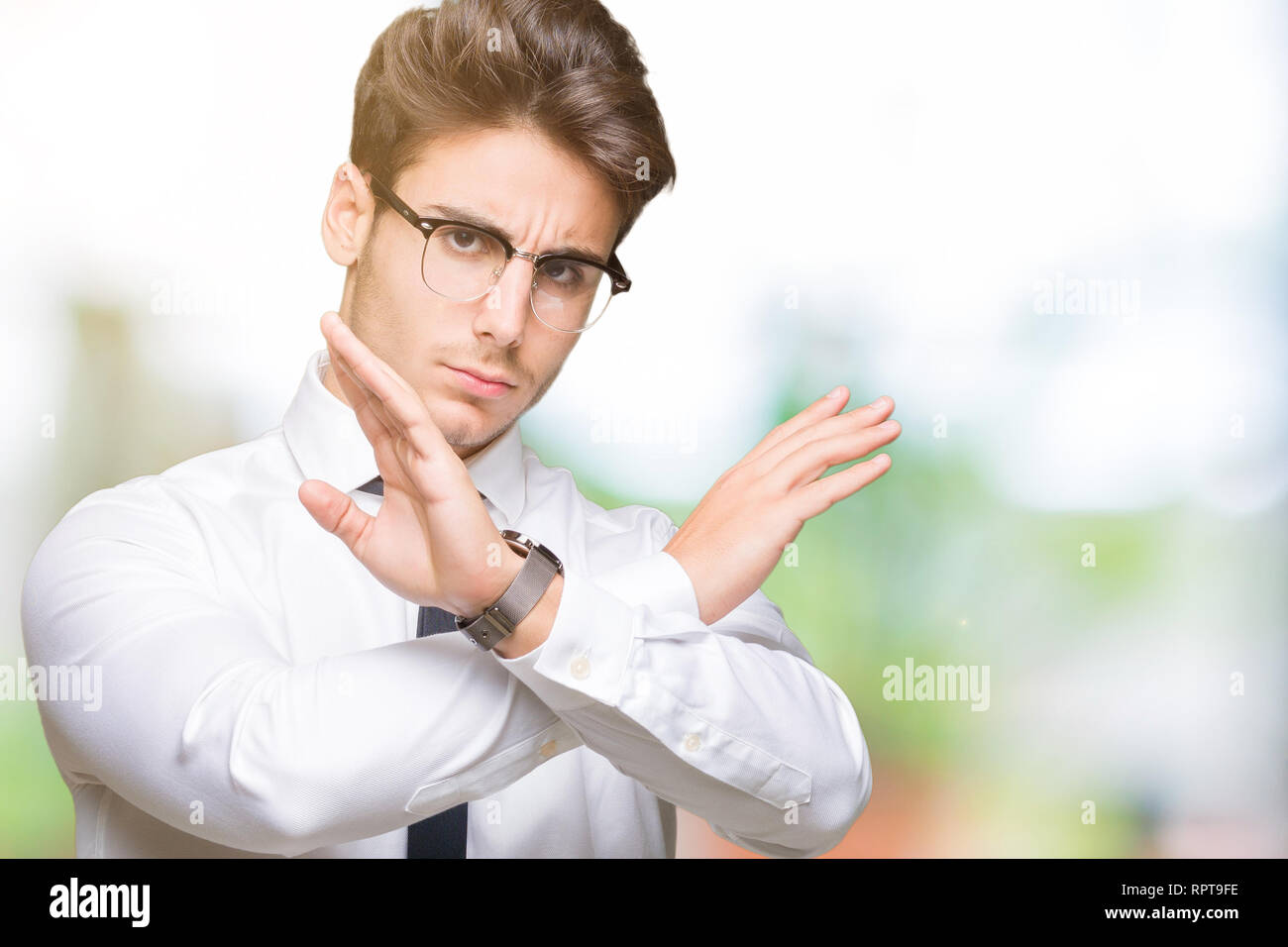 Young business man wearing glasses over isolated background Rejection ...
