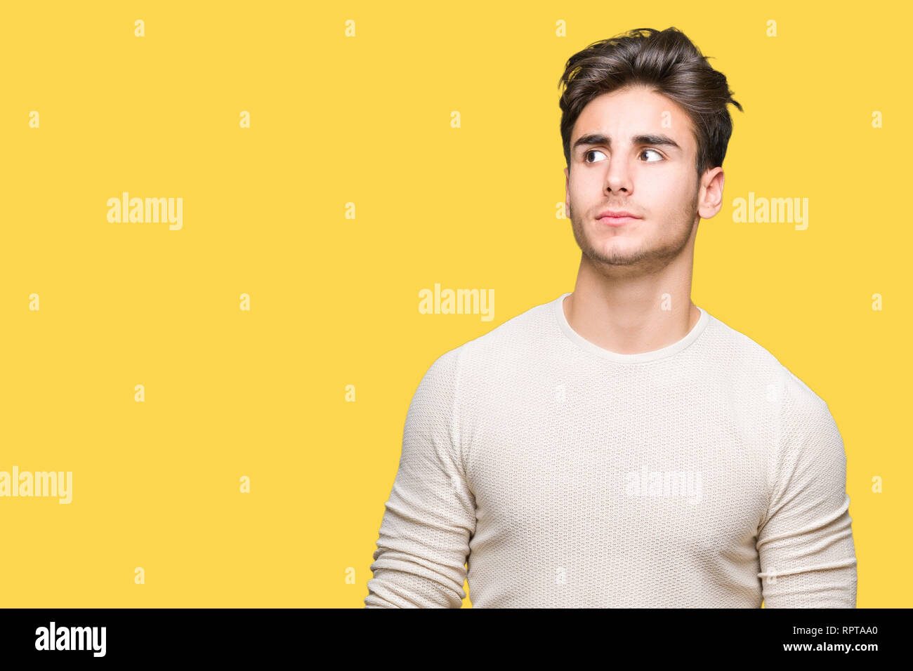 Young handsome man over isolated background smiling looking side and ...