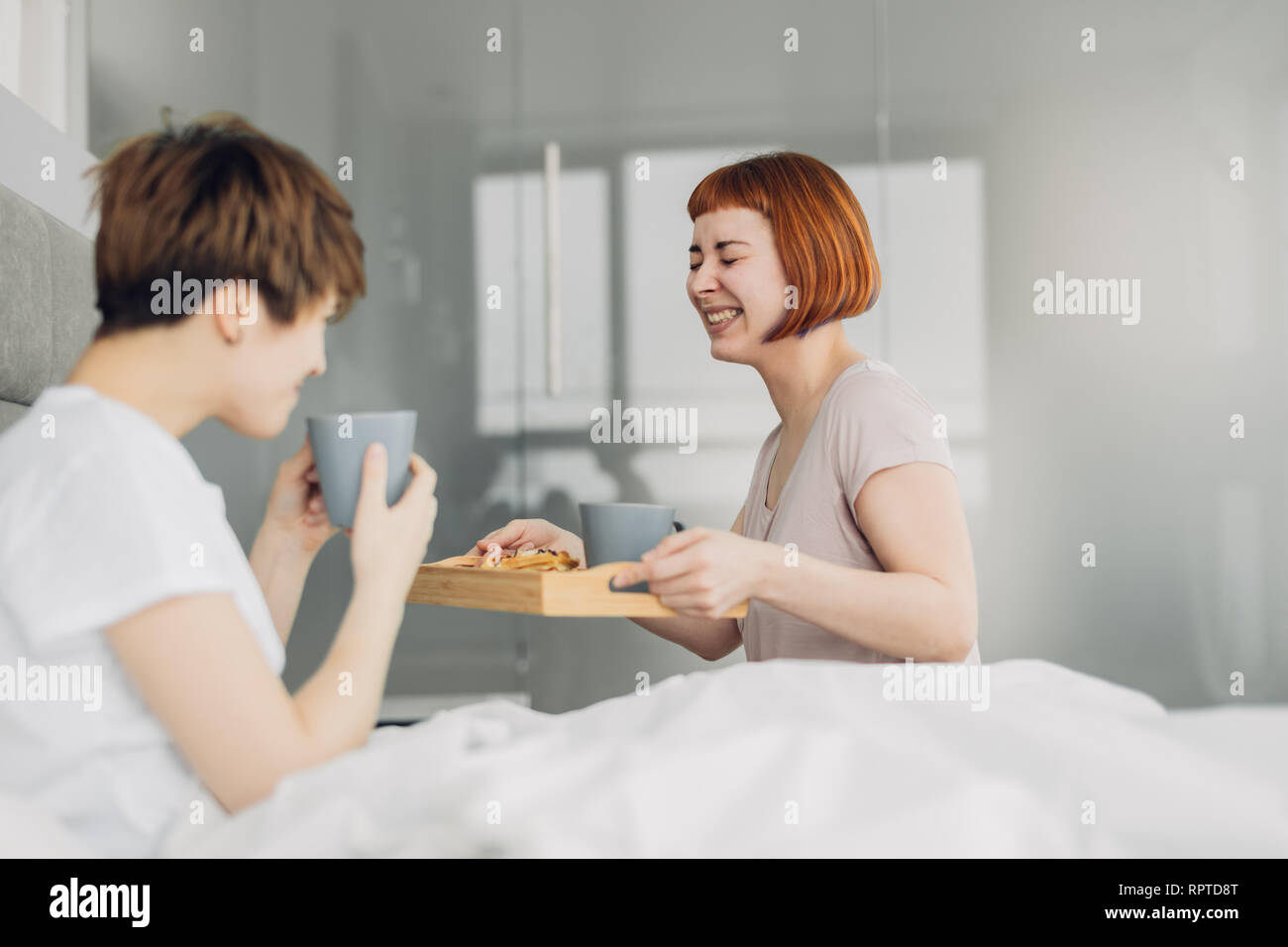 two best friends having fun while drinking tea. close up photo ...